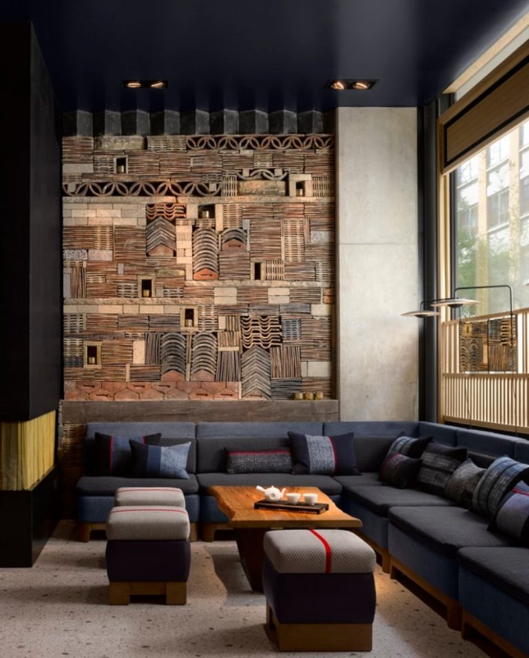 Its modern interior design lobby is characterised by a dark wood and ...
