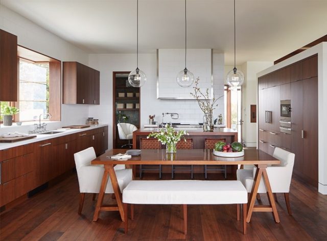 The mahogany kitchen cabinetry and teak flooring are complemented by a ...
